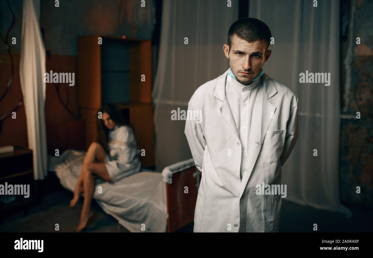 Psychiatrist and crazy patient in strait jacket Stock Photo - Alamy