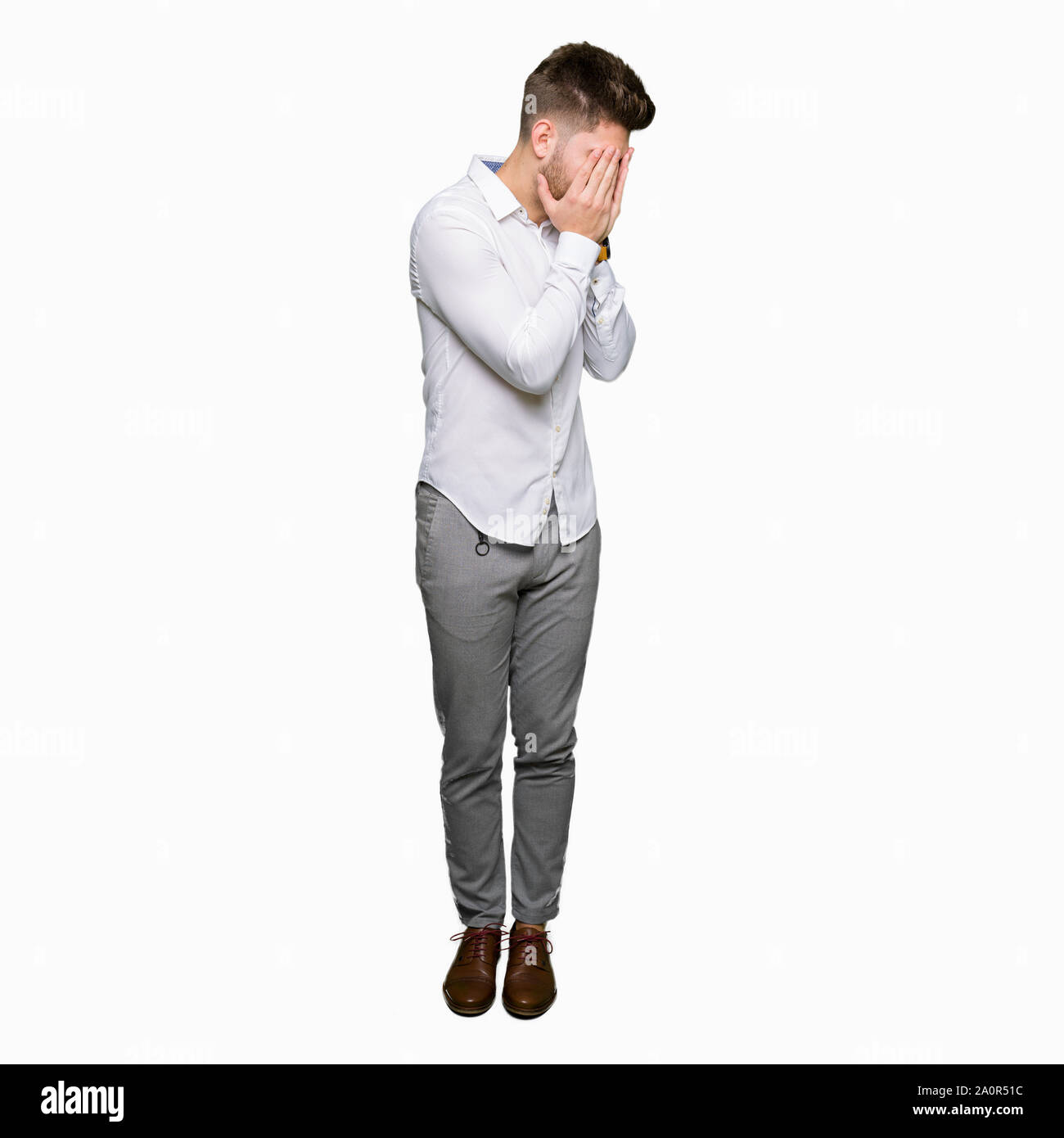 Young handsome business man with sad expression covering face with ...