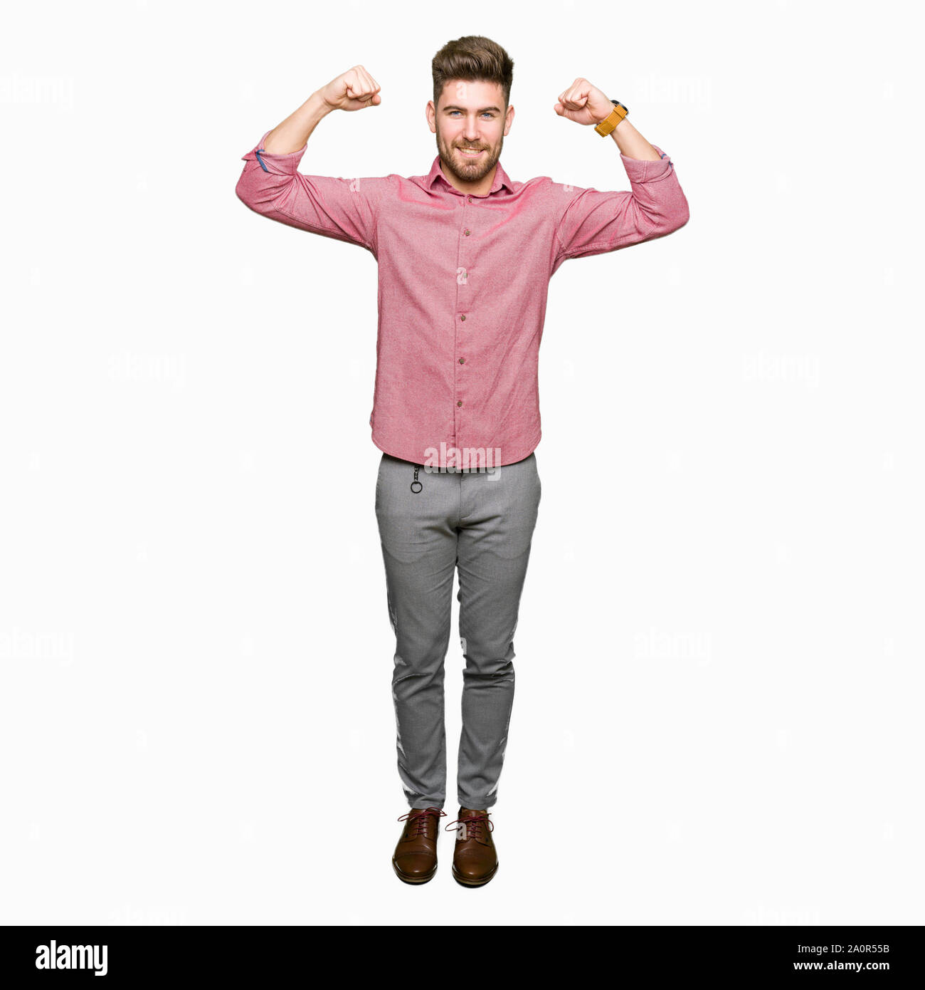 Young handsome business casual man showing arms muscles smiling proud ...