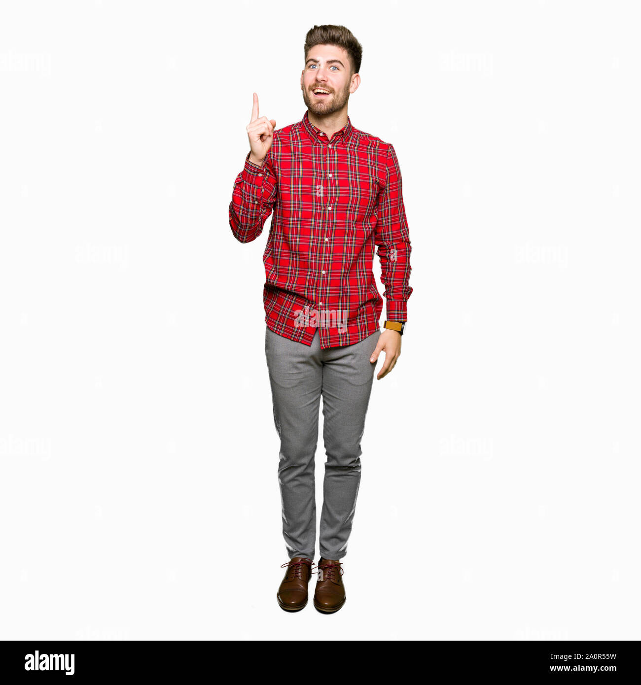 Young handsome man pointing finger up with successful idea. Exited and ...