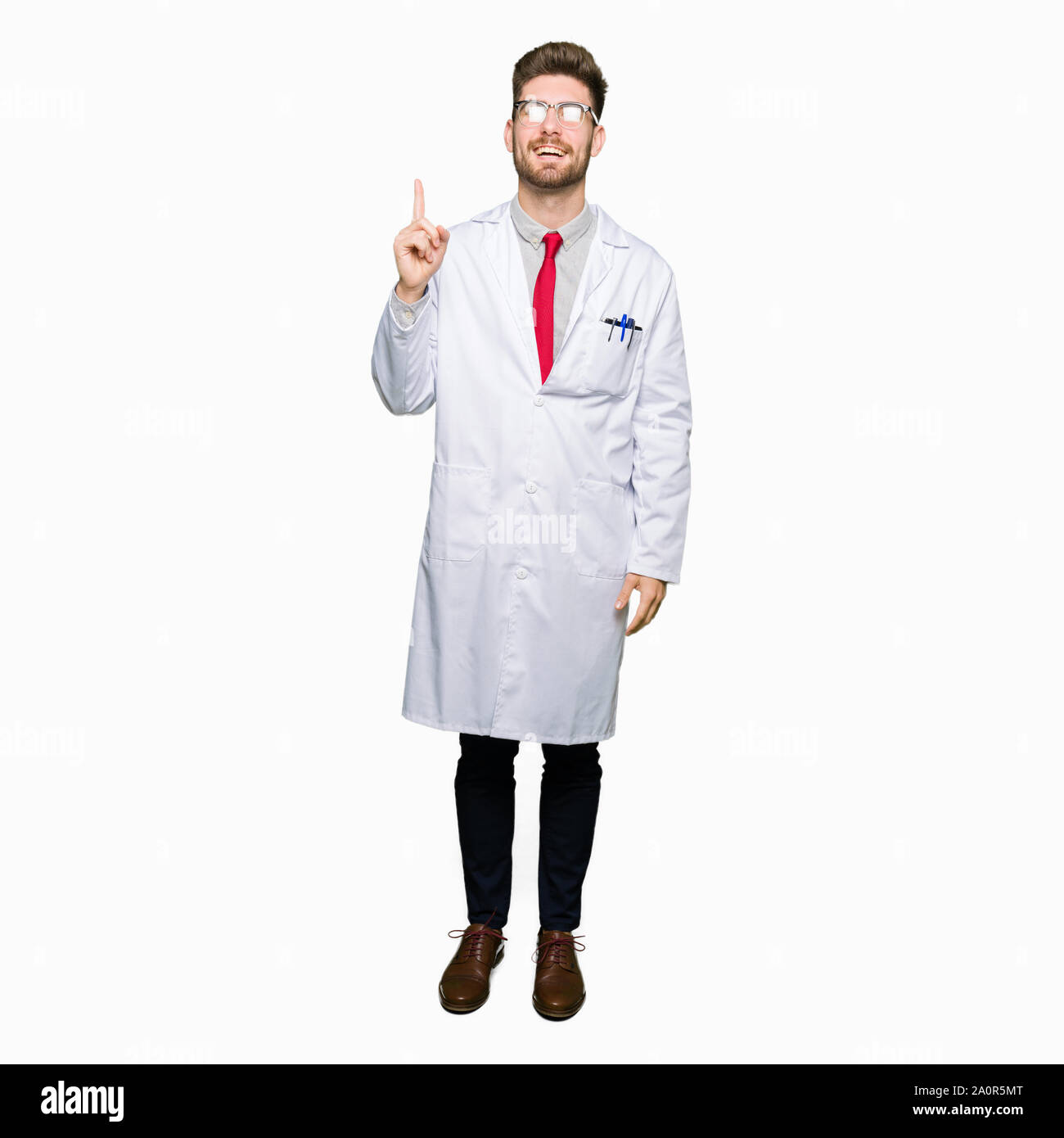 Young handsome scientist man wearing glasses pointing finger up with ...