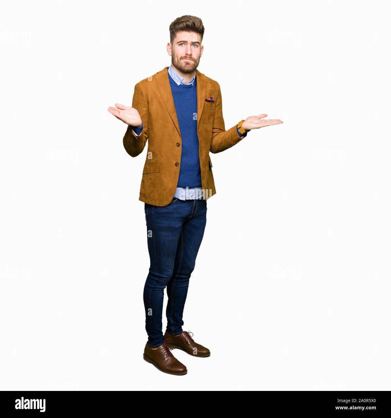Young handsome business man clueless and confused expression with arms ...