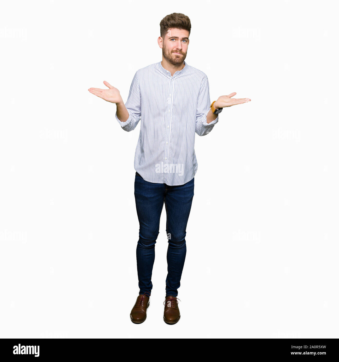 Young handsome man clueless and confused expression with arms and hands ...