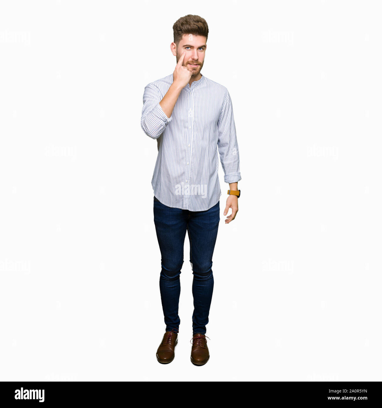 Young handsome man Pointing to the eye watching you gesture, suspicious ...