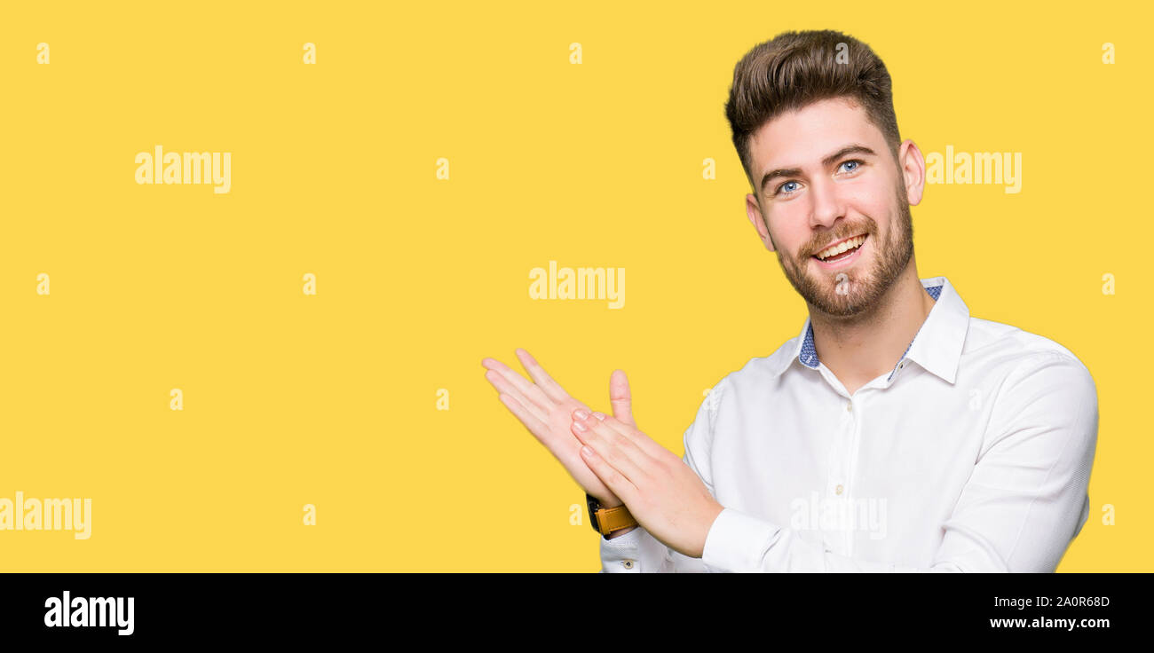 Young handsome business man Clapping and applauding happy and joyful ...