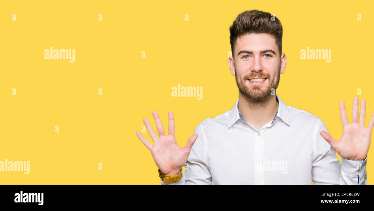 Young handsome business man showing and pointing up with fingers number ...