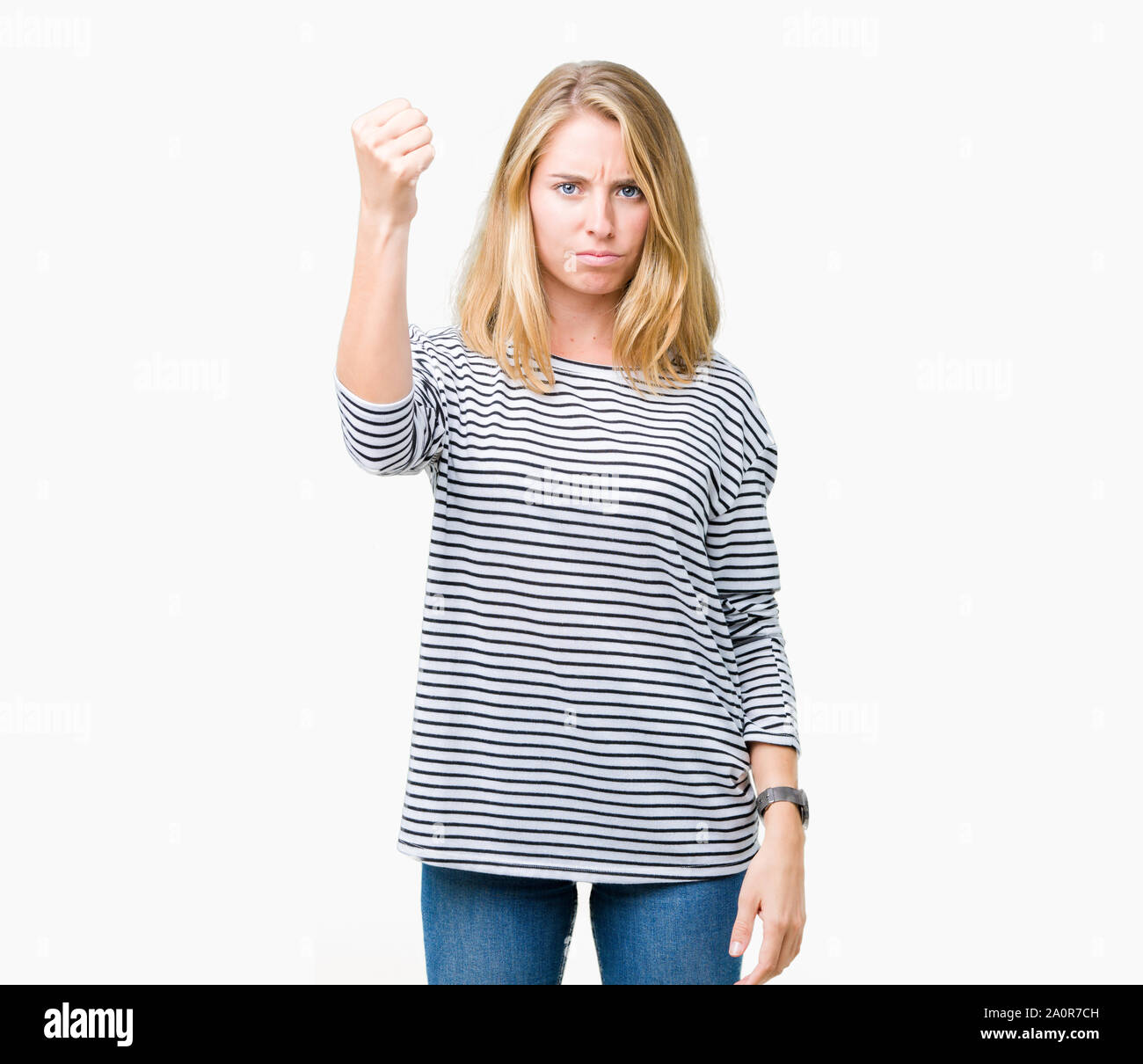 Beautiful young woman wearing stripes sweater over isolated background ...
