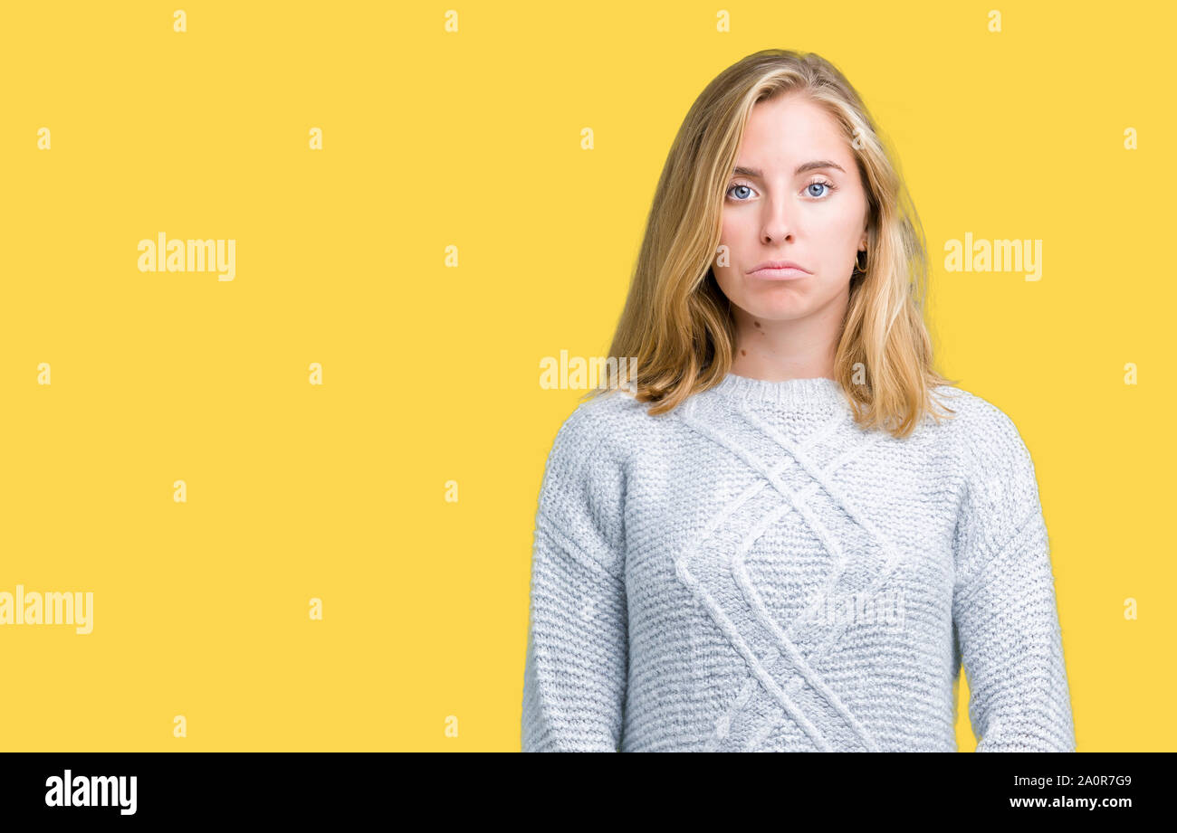 Beautiful young woman wearing winter sweater over isolated background ...