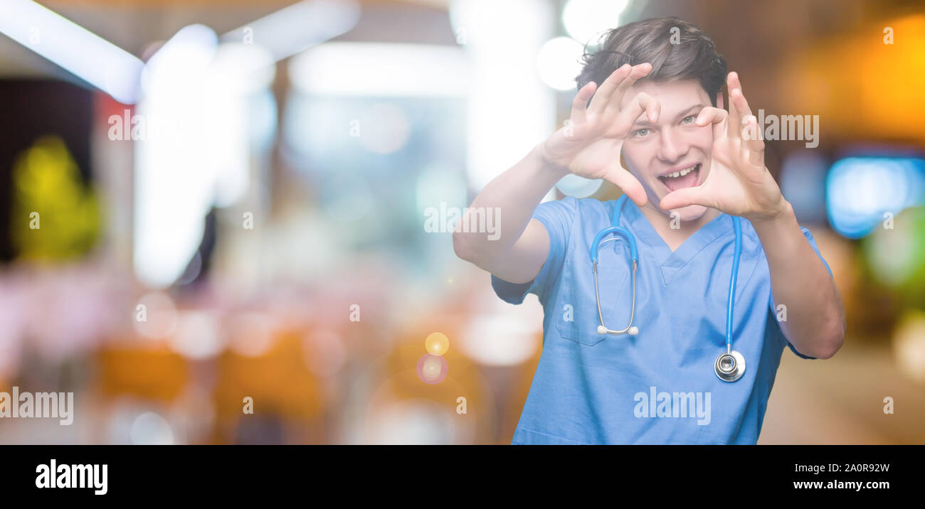 Young doctor wearing medical uniform over isolated background smiling ...