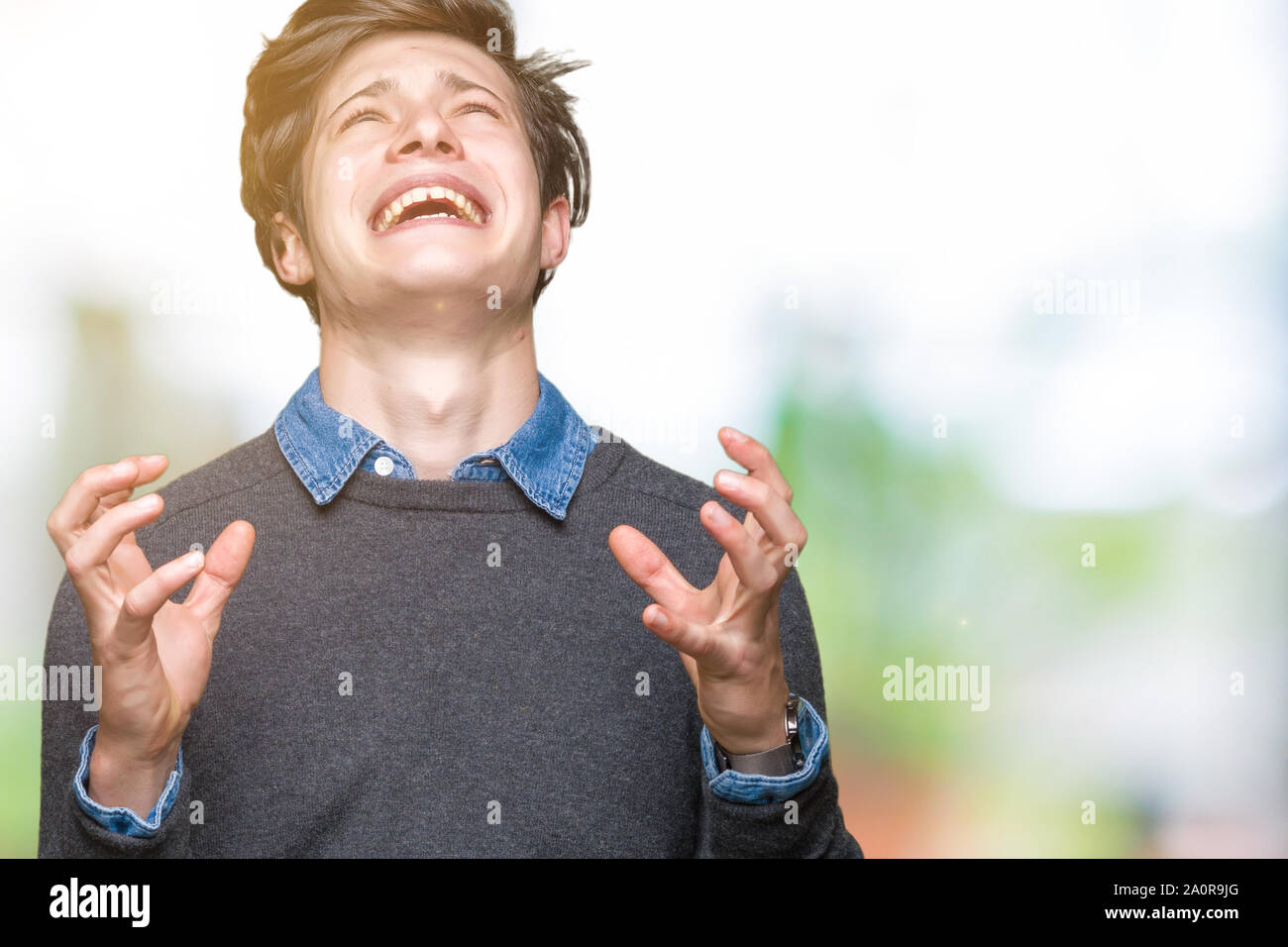 Young handsome elegant man over isolated background crazy and mad ...