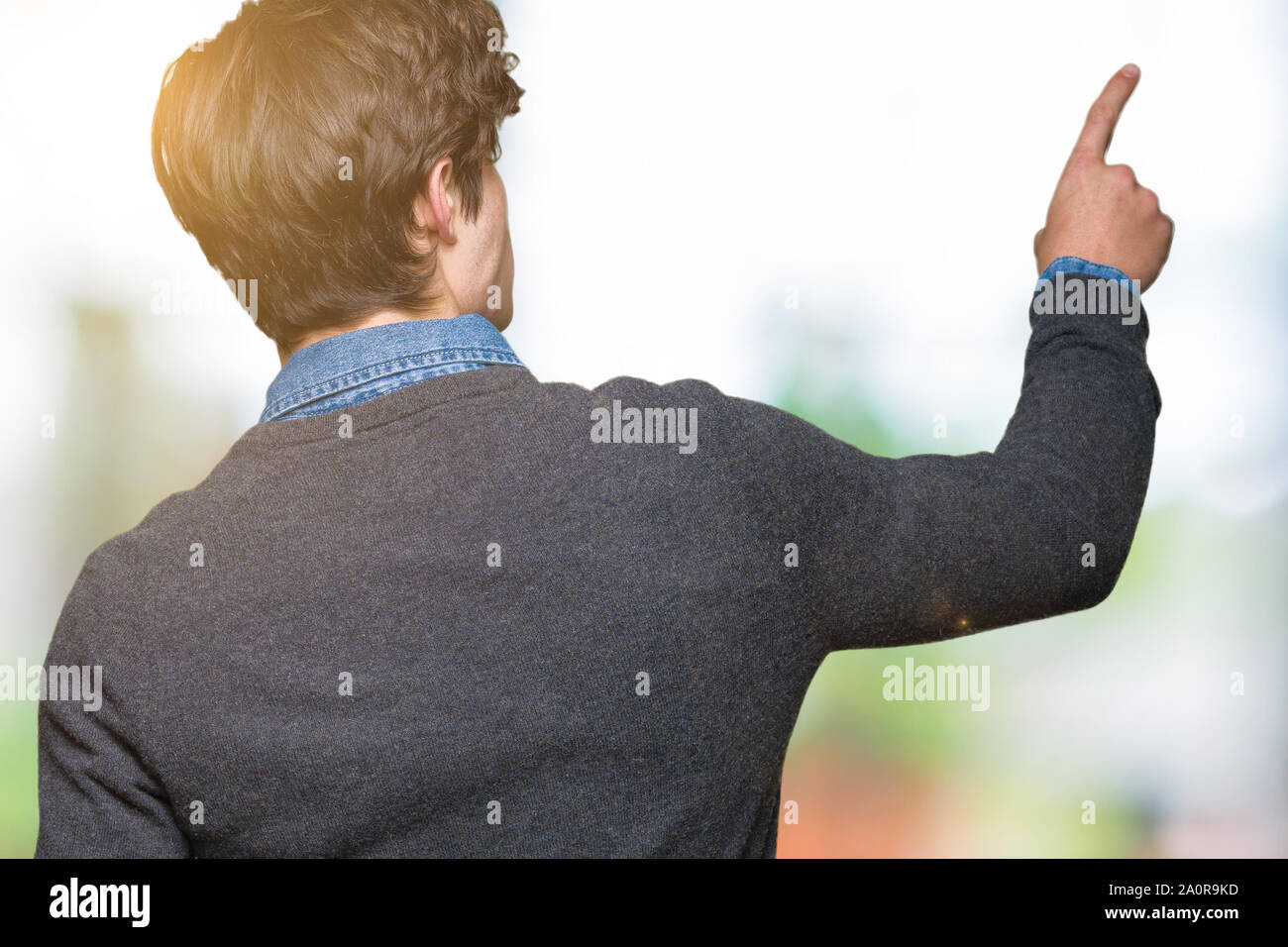 Young handsome elegant man over isolated background Posing backwards ...