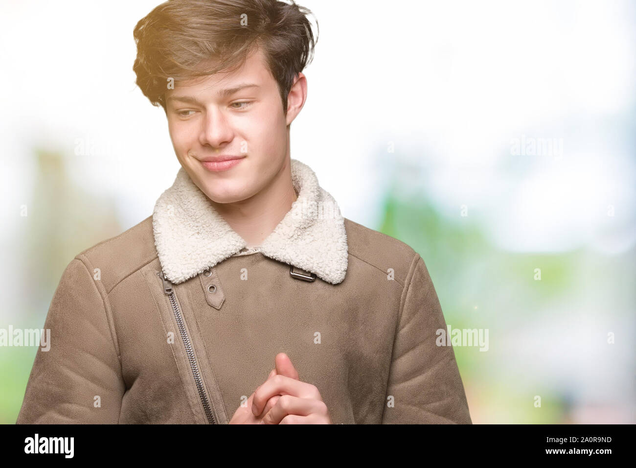 Young handsome man wearing winter coat over isolated background Hands ...