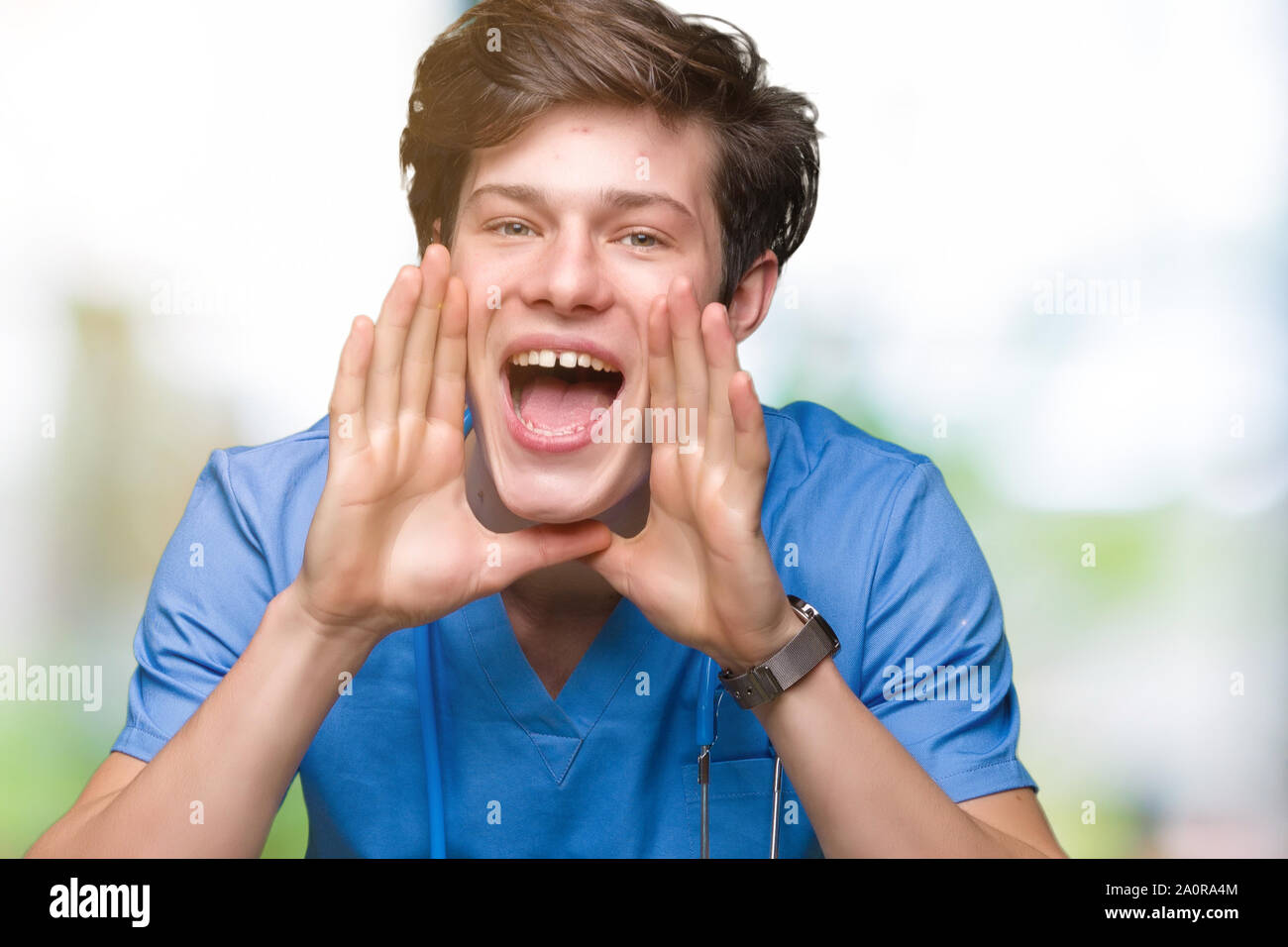 Young doctor wearing medical uniform over isolated background Shouting ...