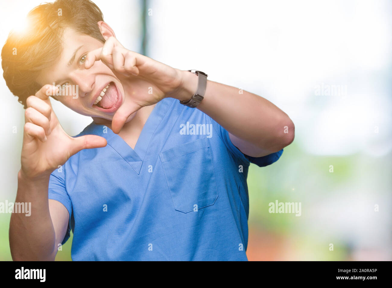 Young doctor wearing medical uniform over isolated background smiling ...