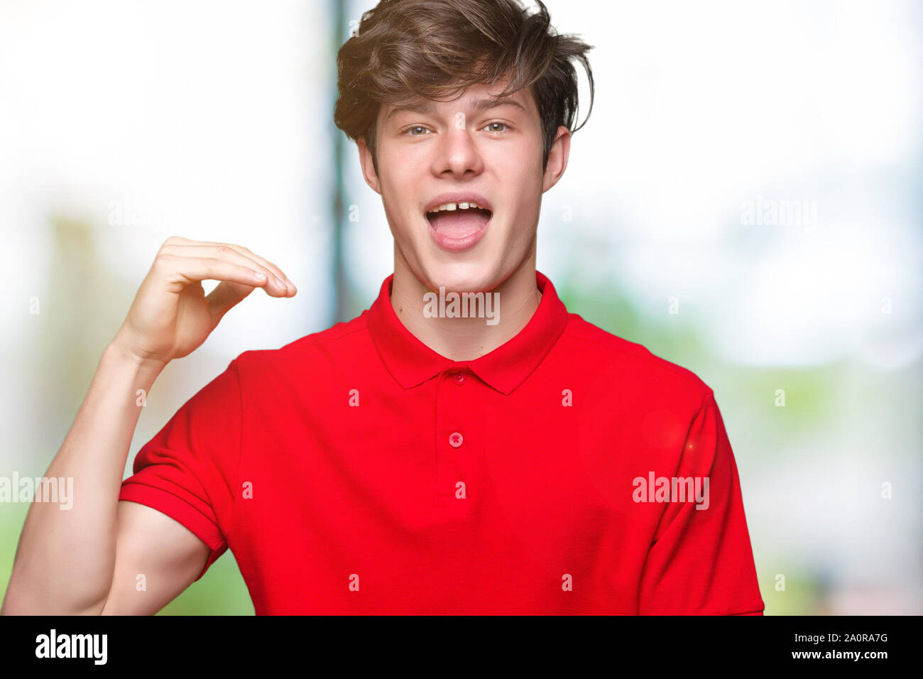 Young handsome man wearing red t-shirt over isolated background ...