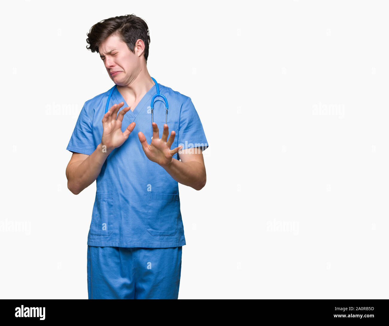 Young doctor wearing medical uniform over isolated background disgusted ...