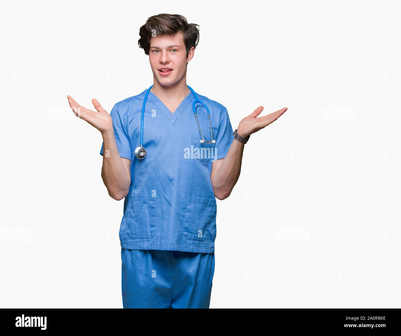 Young doctor wearing medical uniform over isolated background Smiling ...