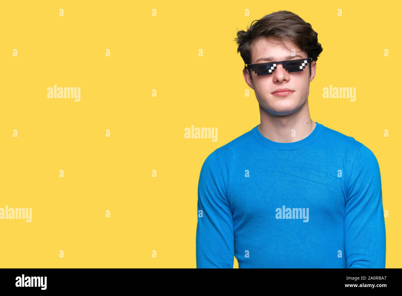Young man wearing funny thug life glasses over isolated background with ...