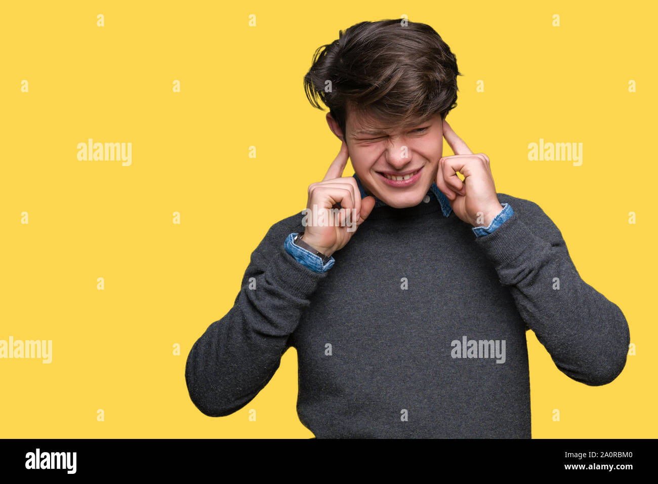 Young handsome elegant man over isolated background covering ears with ...