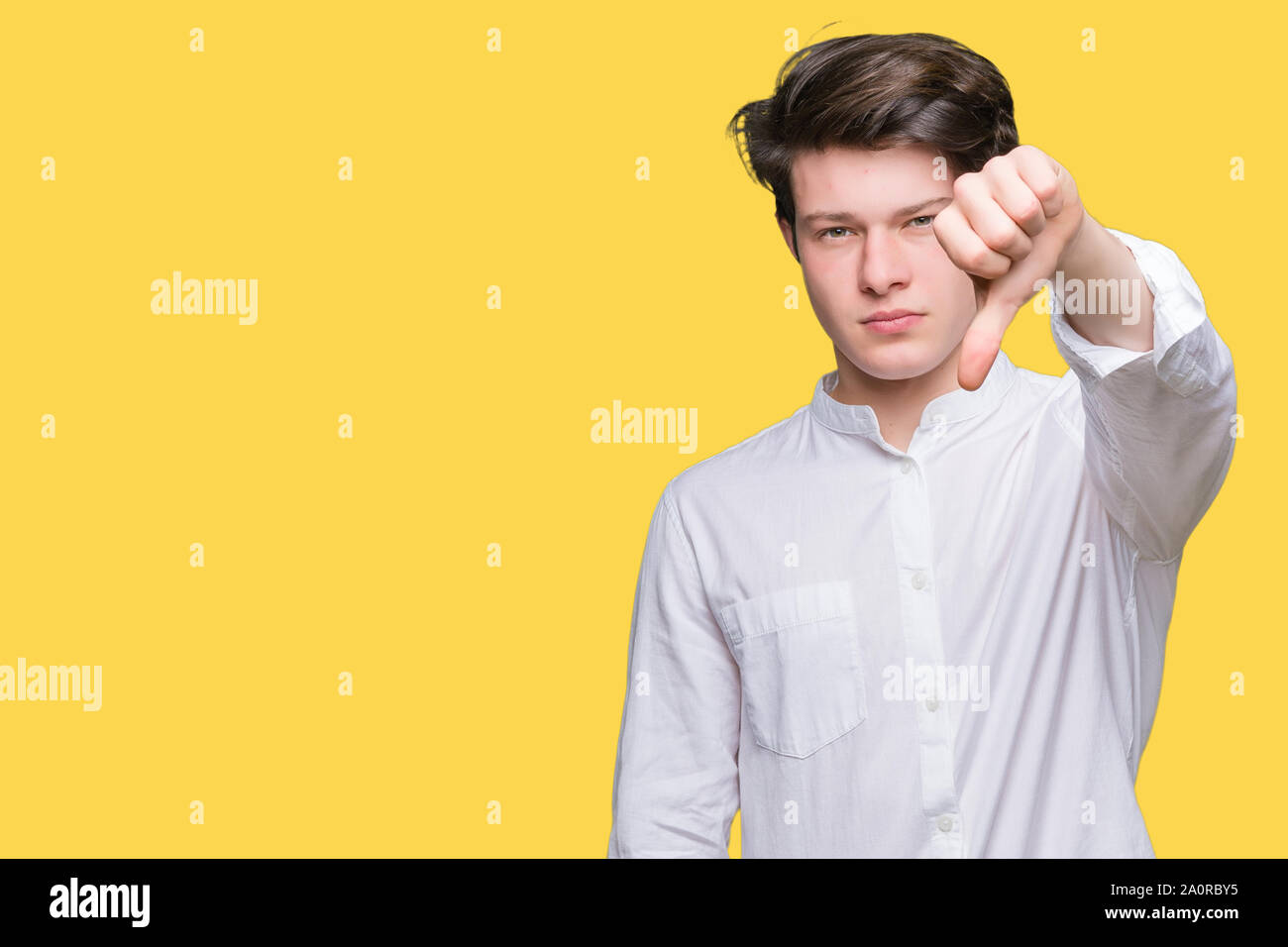 Young handsome business man over isolated background looking unhappy ...