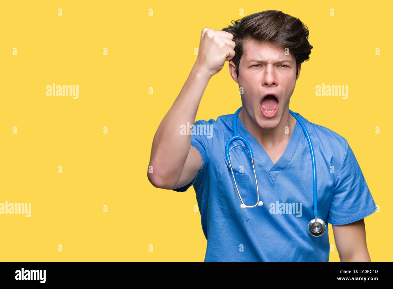 Young doctor wearing medical uniform over isolated background angry and ...