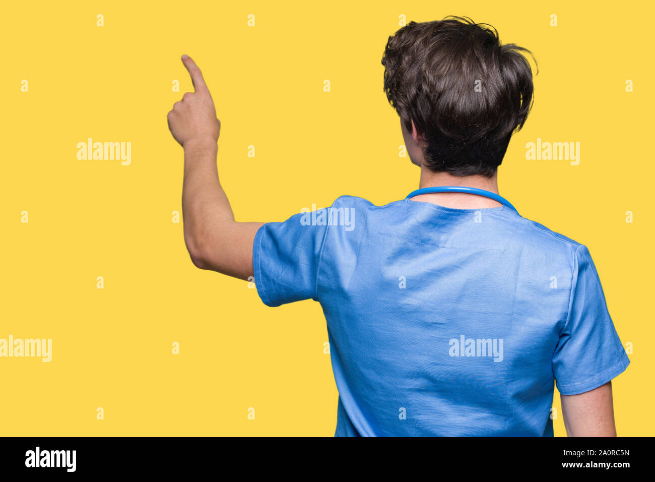 Young doctor wearing medical uniform over isolated background Posing ...