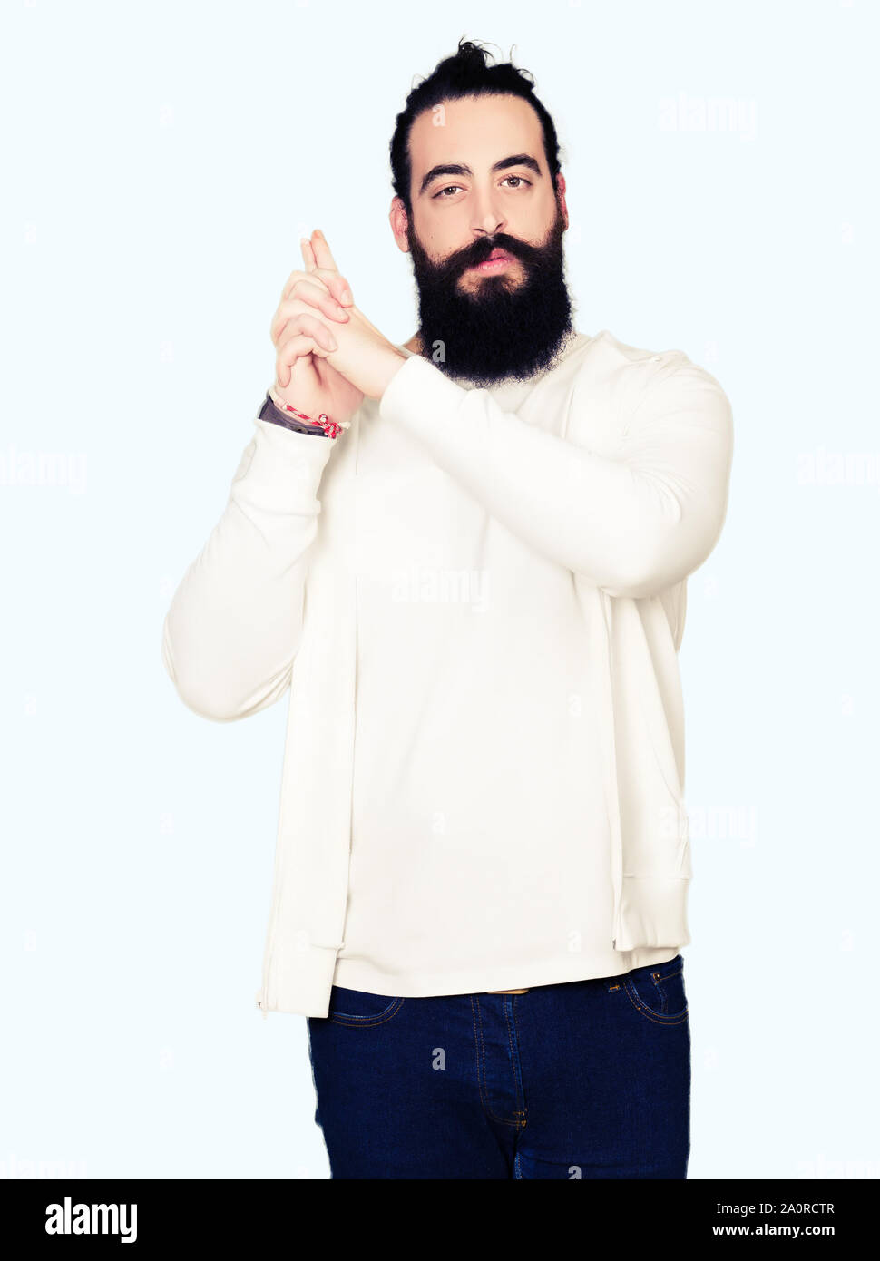 Young hipster man with long hair and beard wearing sporty sweatshirt ...