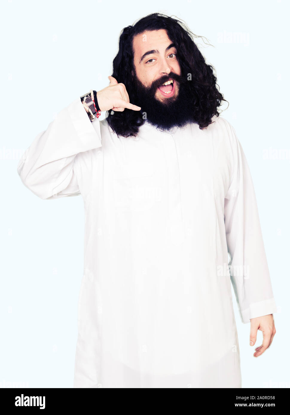 Man wearing Jesus Christ costume smiling doing phone gesture with hand ...