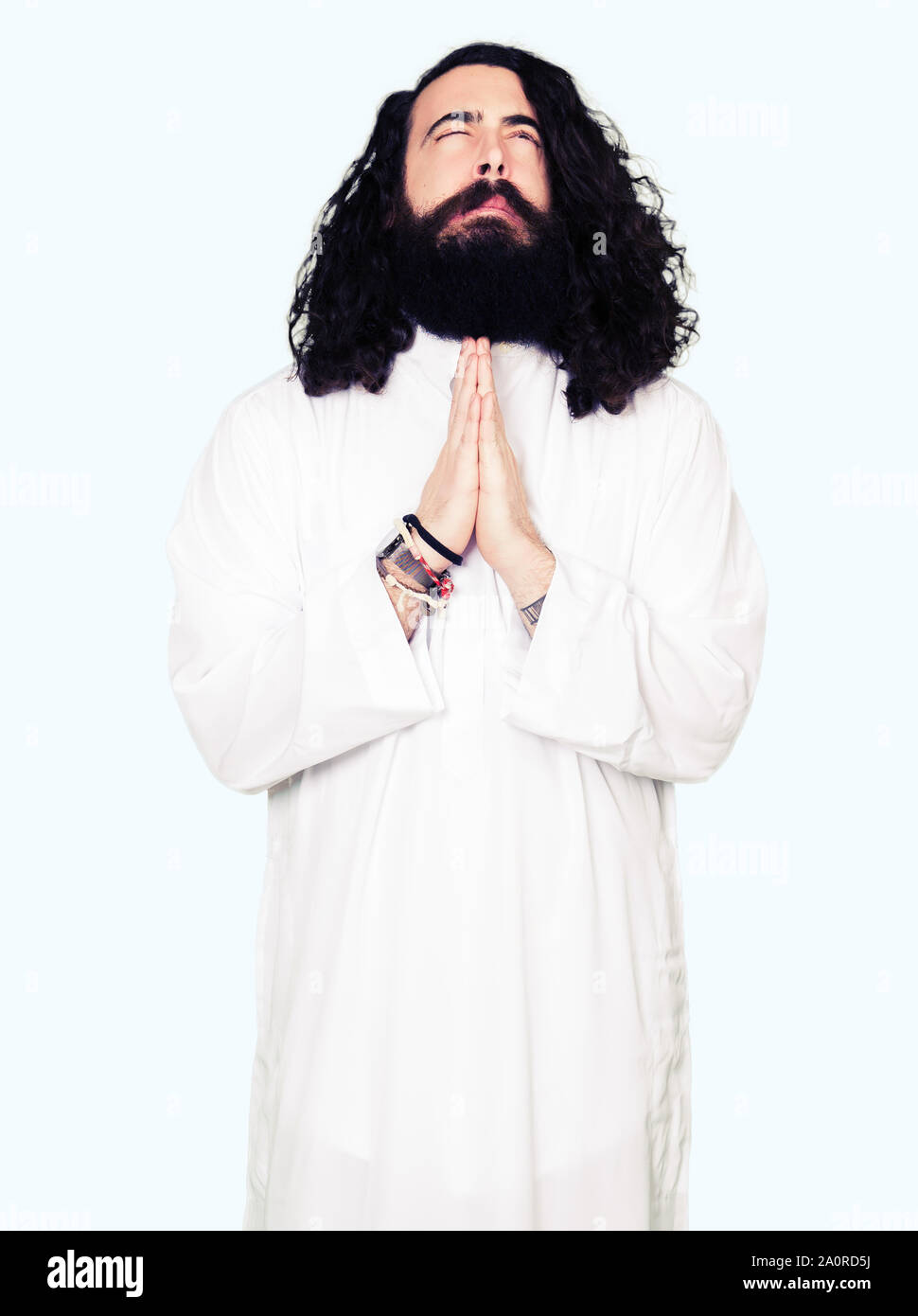 Man wearing Jesus Christ costume begging and praying with hands ...