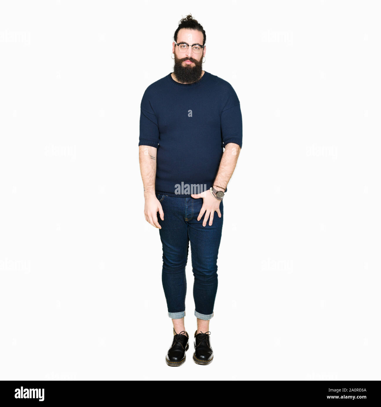 Young hipster man with long hair and beard wearing glasses depressed ...