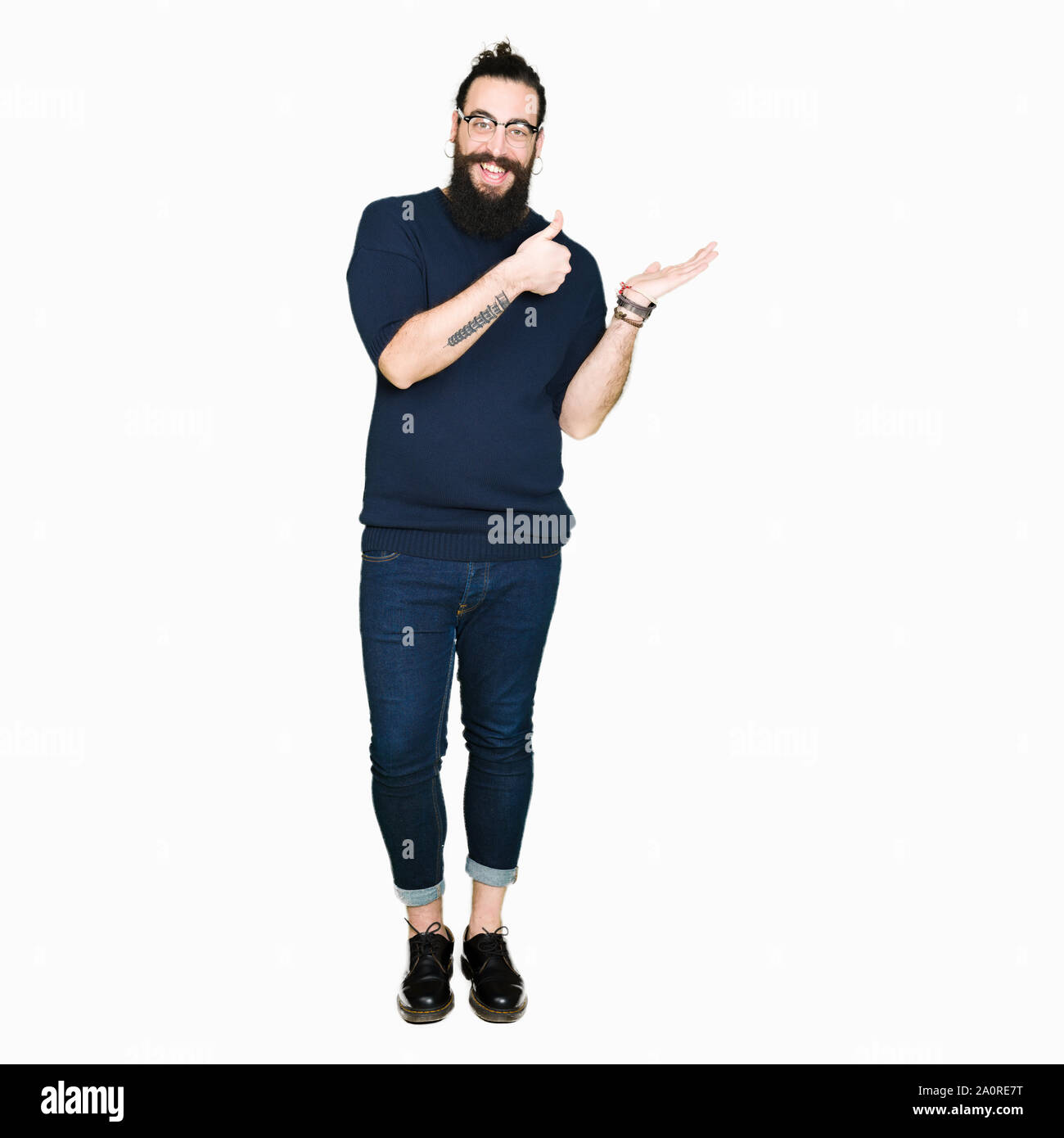 Young hipster man with long hair and beard wearing glasses Showing palm ...