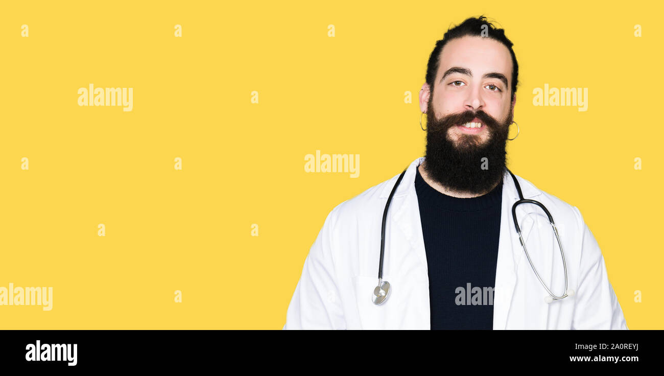 Doctor with long hair wearing medical coat and stethoscope with a happy ...