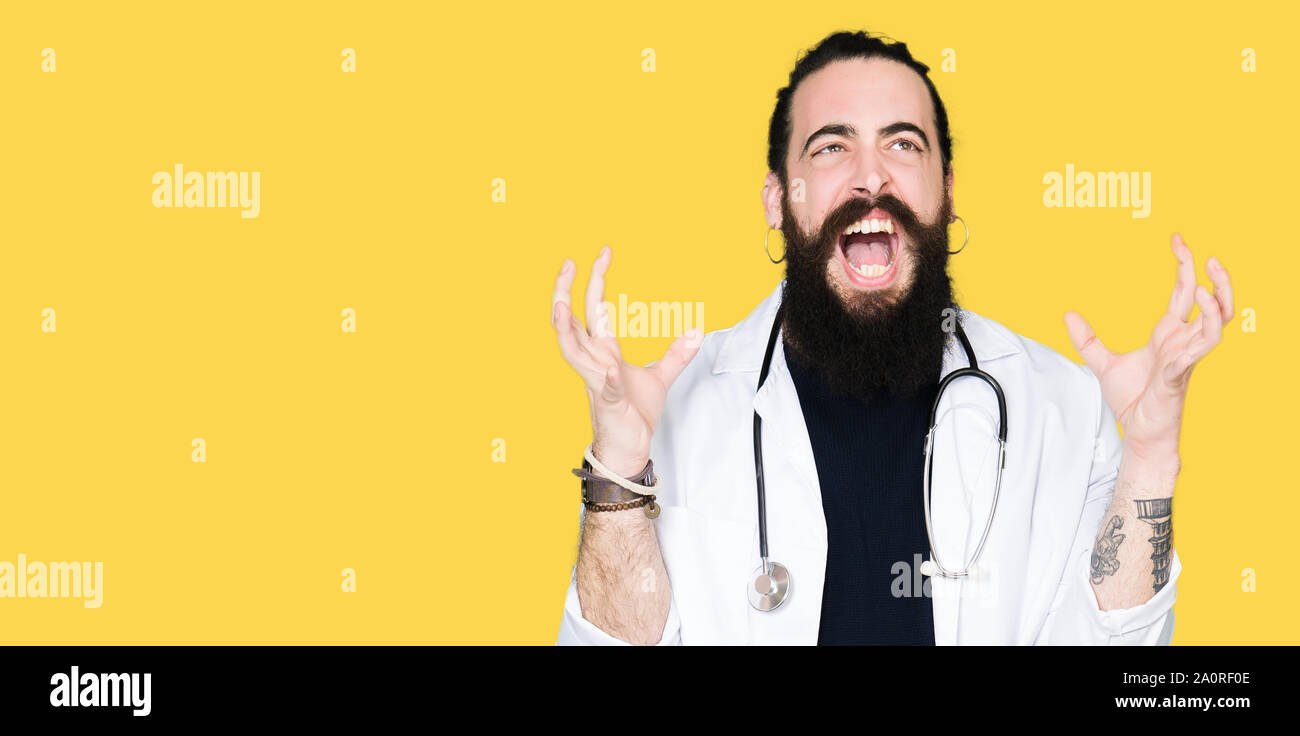 Doctor with long hair wearing medical coat and stethoscope crazy and ...