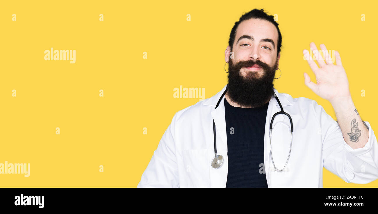Doctor with long hair wearing medical coat and stethoscope Waiving ...