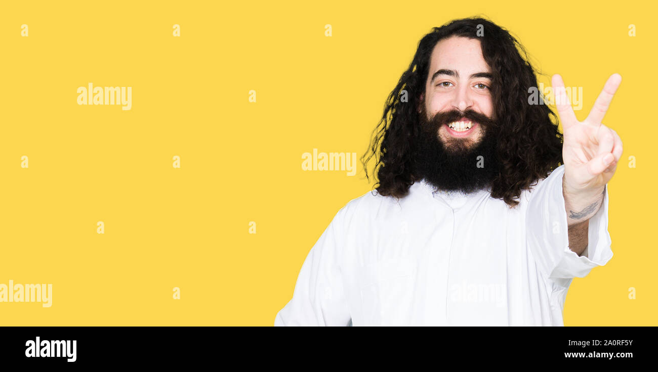 Man wearing Jesus Christ costume showing and pointing up with fingers ...