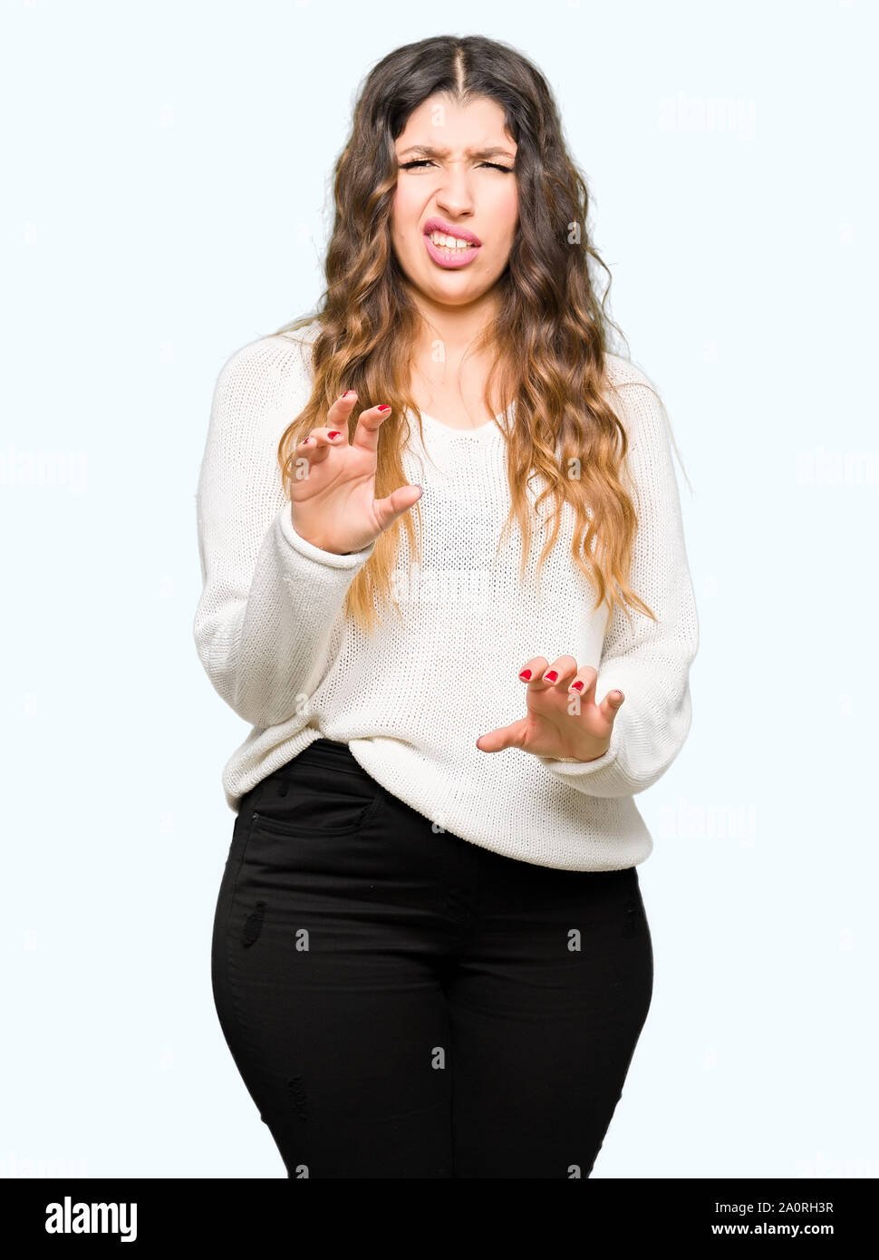 Young beautiful woman wearing white sweater disgusted expression ...