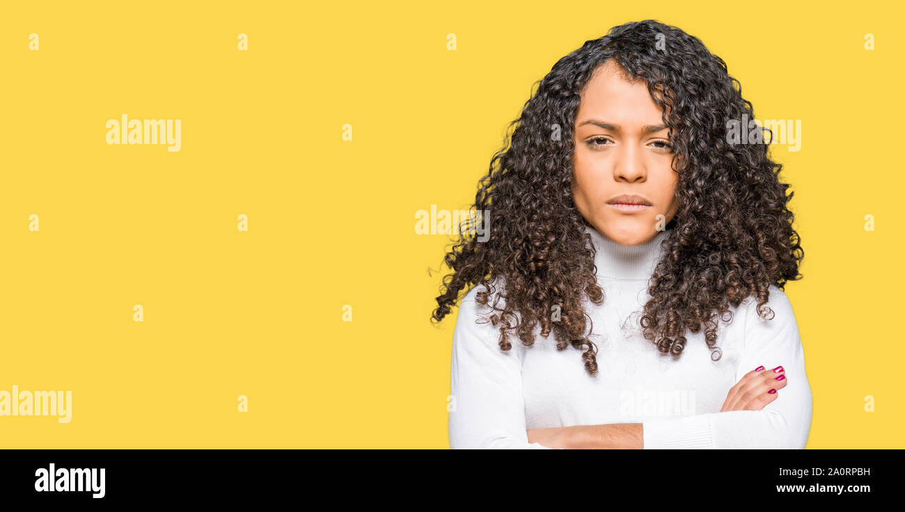 Young beautiful woman with curly hair wearing turtleneck sweater ...