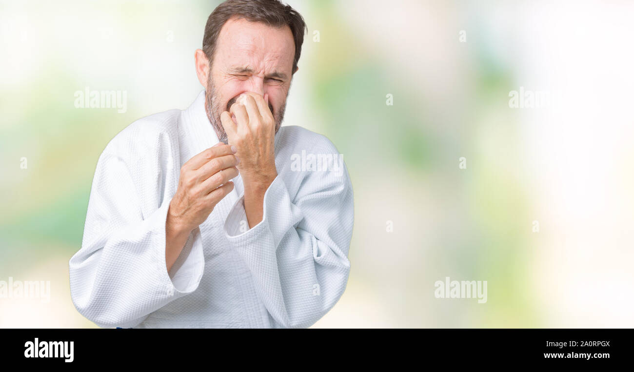 Handsome middle age senior man wearing kimono uniform over isolated ...