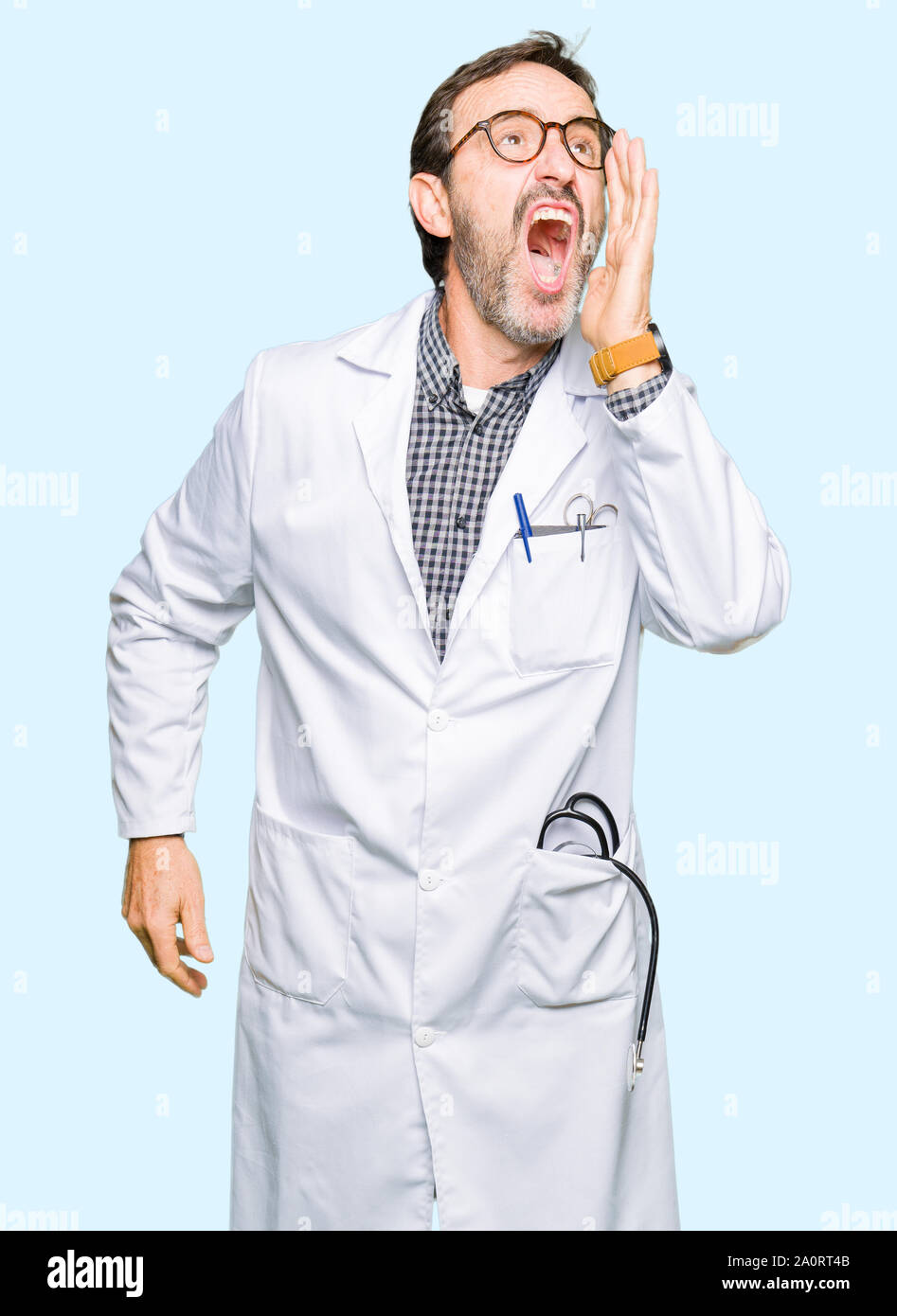 Middle age doctor men wearing medical coat shouting and screaming loud ...