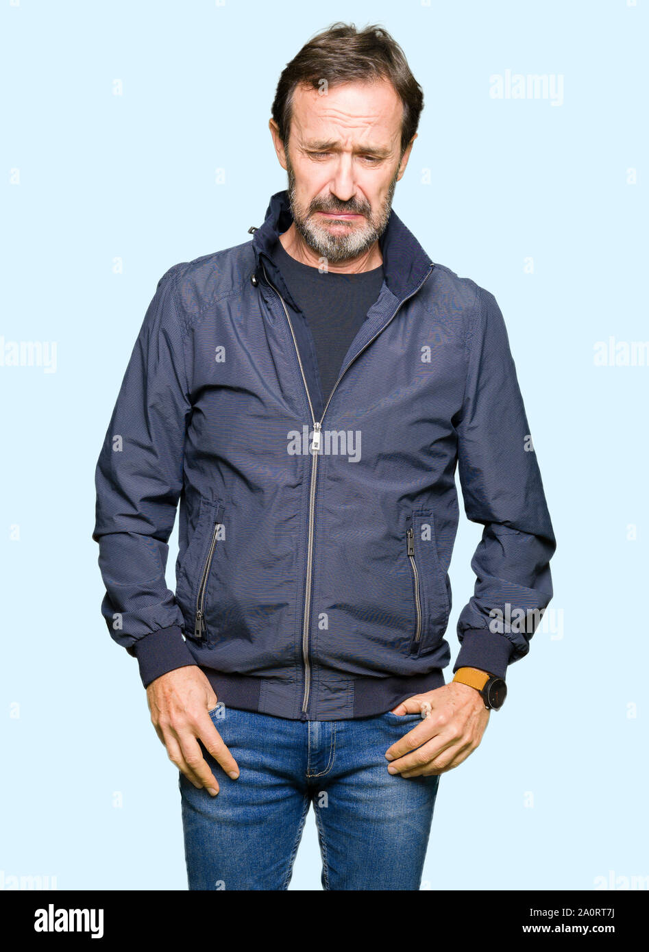 Middle age handsome man wearing a jacket depressed and worry for ...