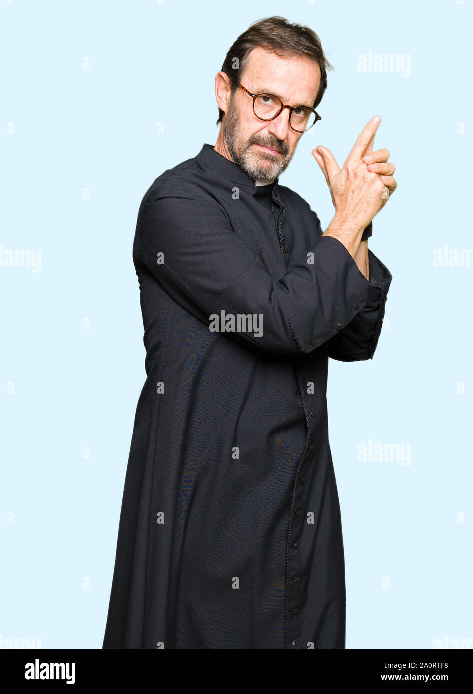 Priest holding gun hi-res stock photography and images - Alamy