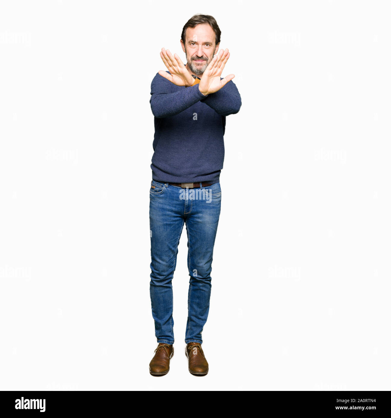 Middle age handsome man wearing a sweater Rejection expression crossing ...