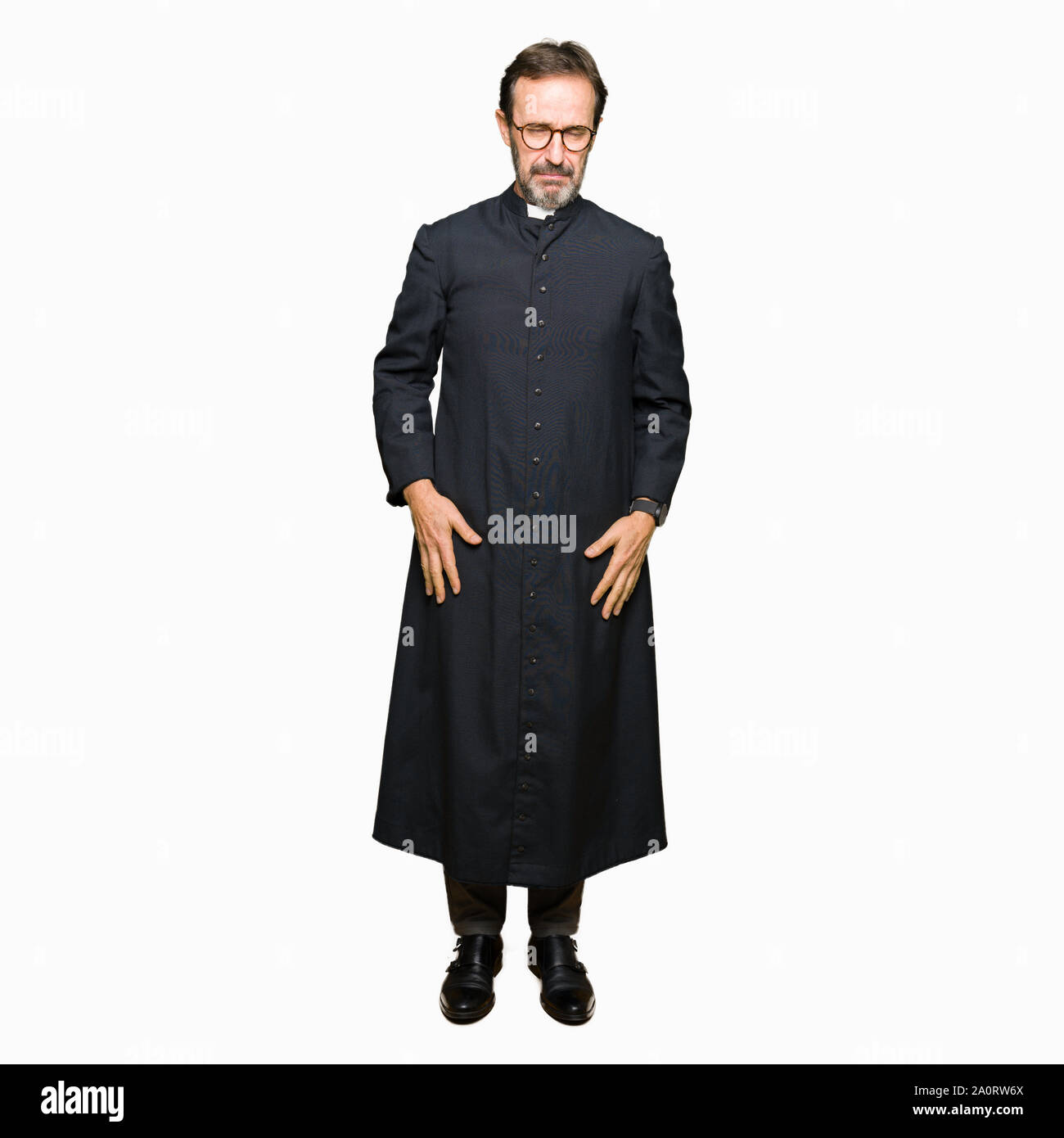 Middle age priest man wearing catholic robe depressed and worry for ...