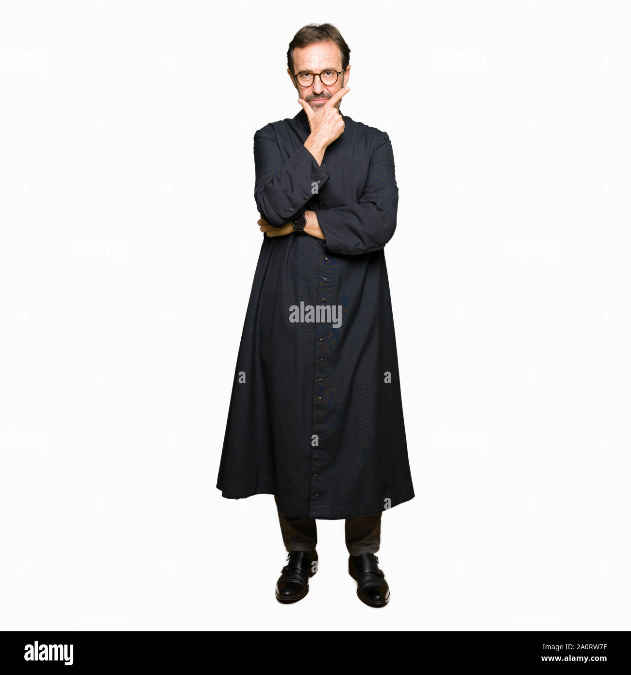 Middle age priest man wearing catholic robe looking confident at the ...