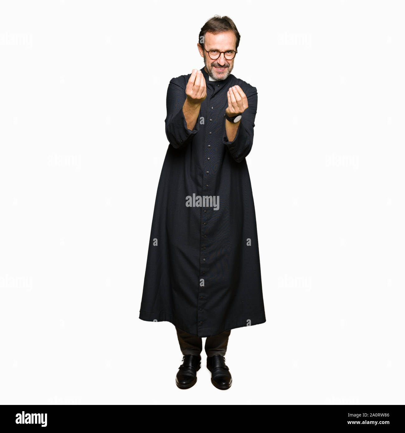 Middle age priest man wearing catholic robe Doing money gesture with ...