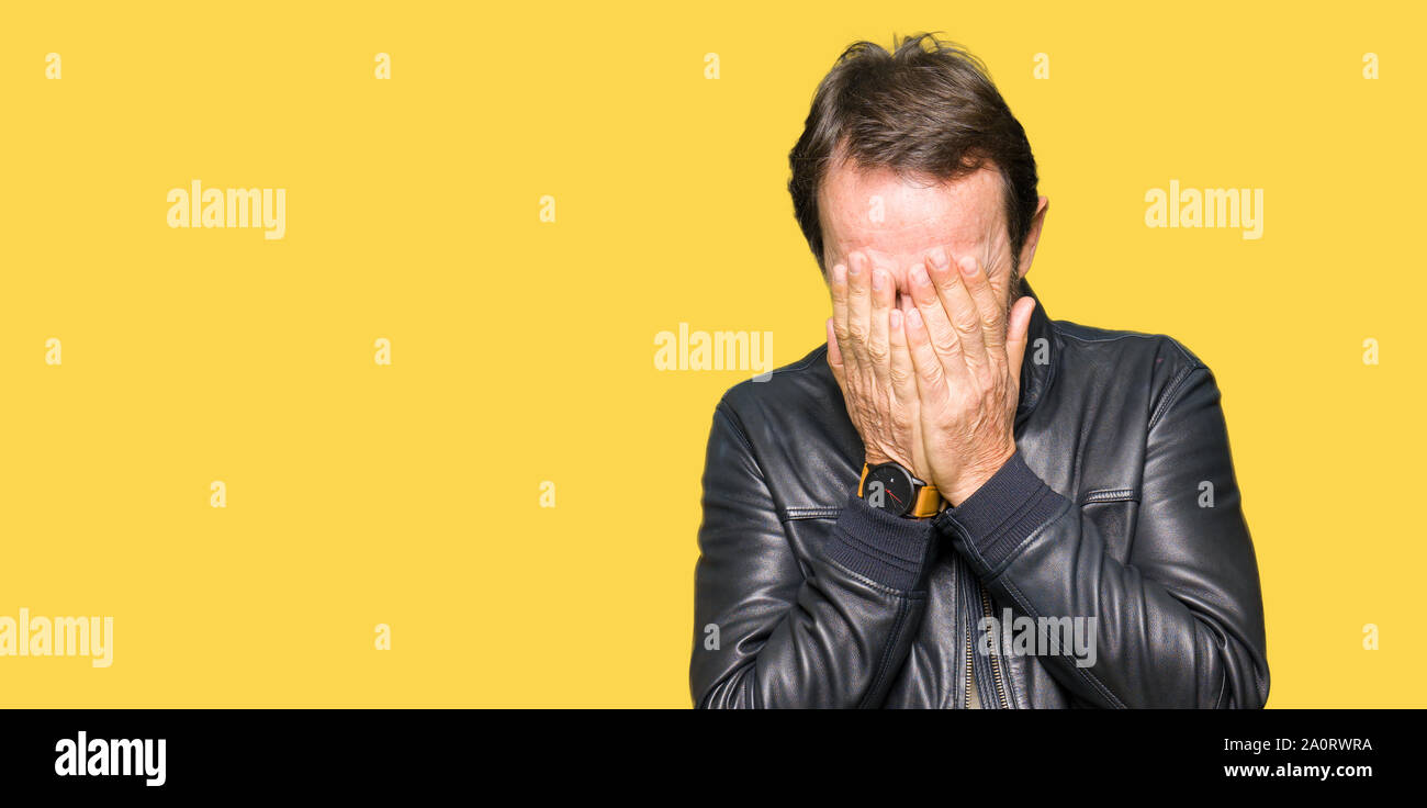 Middle age handsome man wearing black leather jacket with sad ...