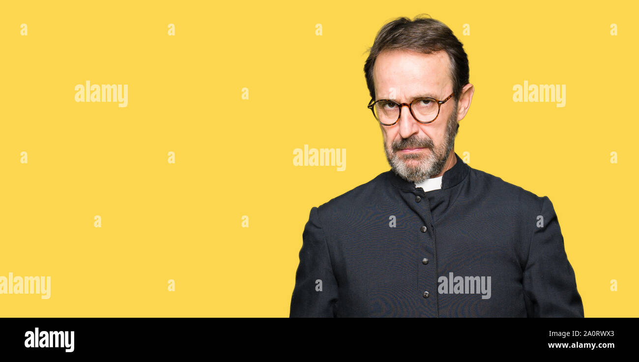 Middle age priest man wearing catholic robe skeptic and nervous ...