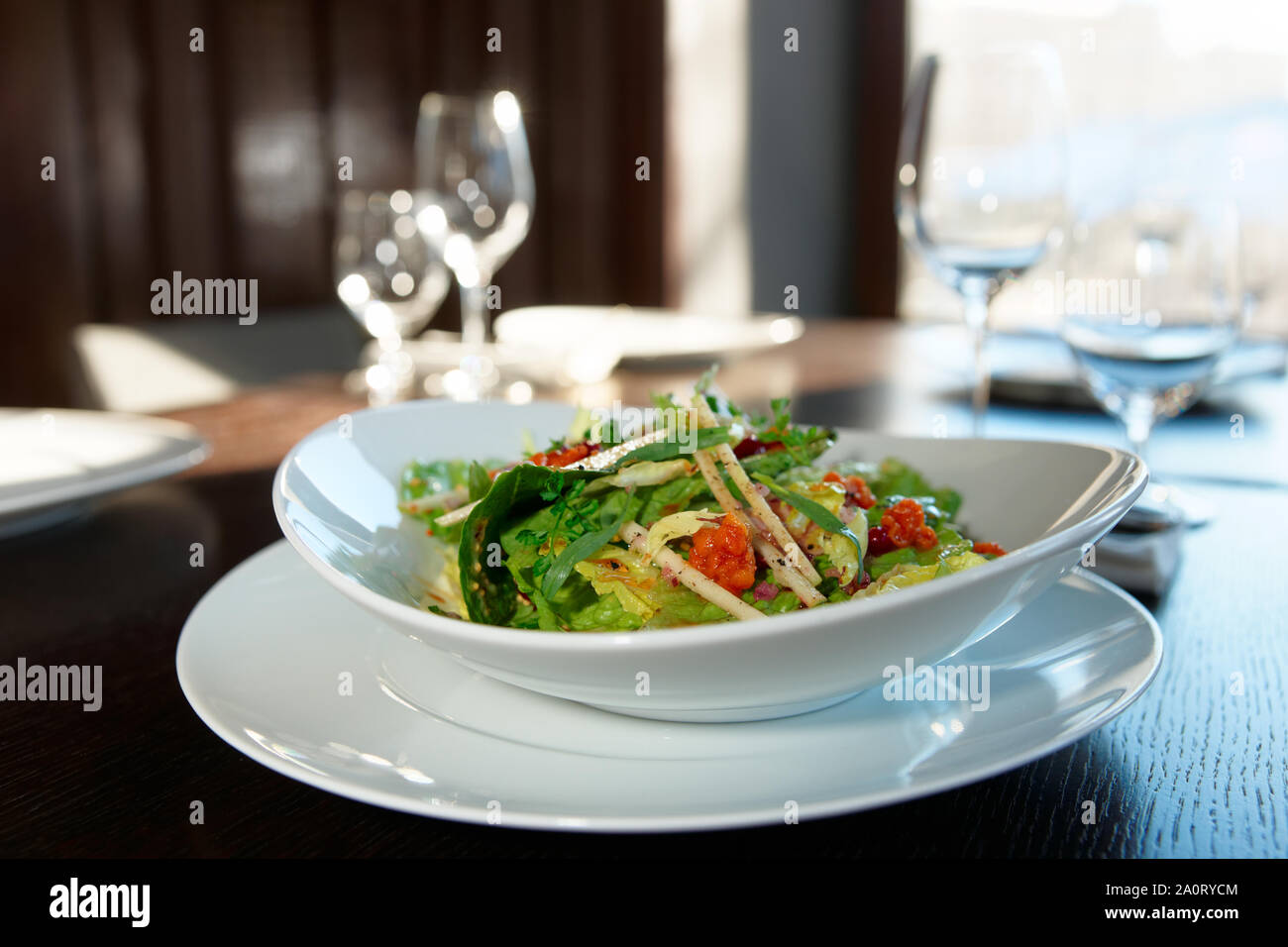Green salad on arranged restaurant table Stock Photo - Alamy