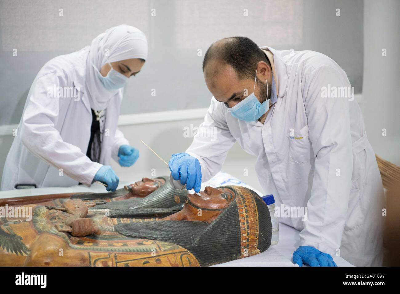 Cairo, Egypt. 21st Sep, 2019. Archaeologists work on the covers of a ...