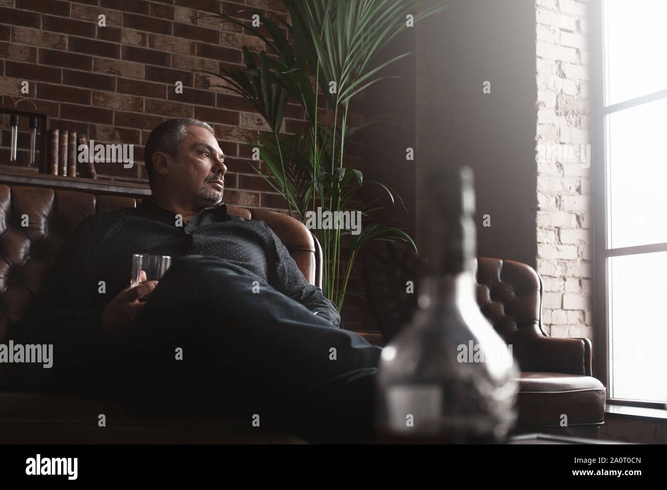 Relaxing after a hard working day. Confident mature businessman sitting ...